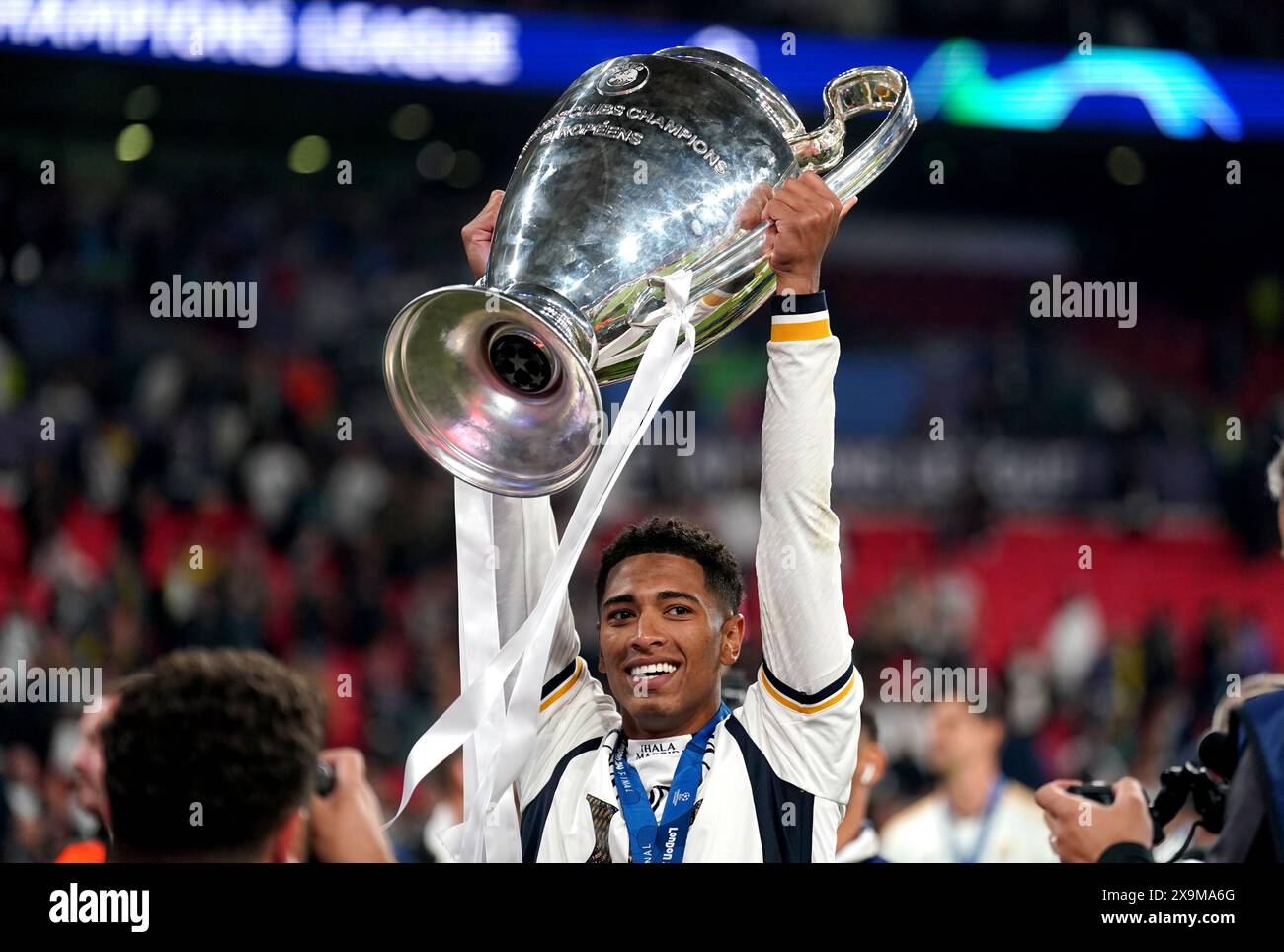 Real Madrid's Jude Bellingham celebrates with the trophy after winning ...