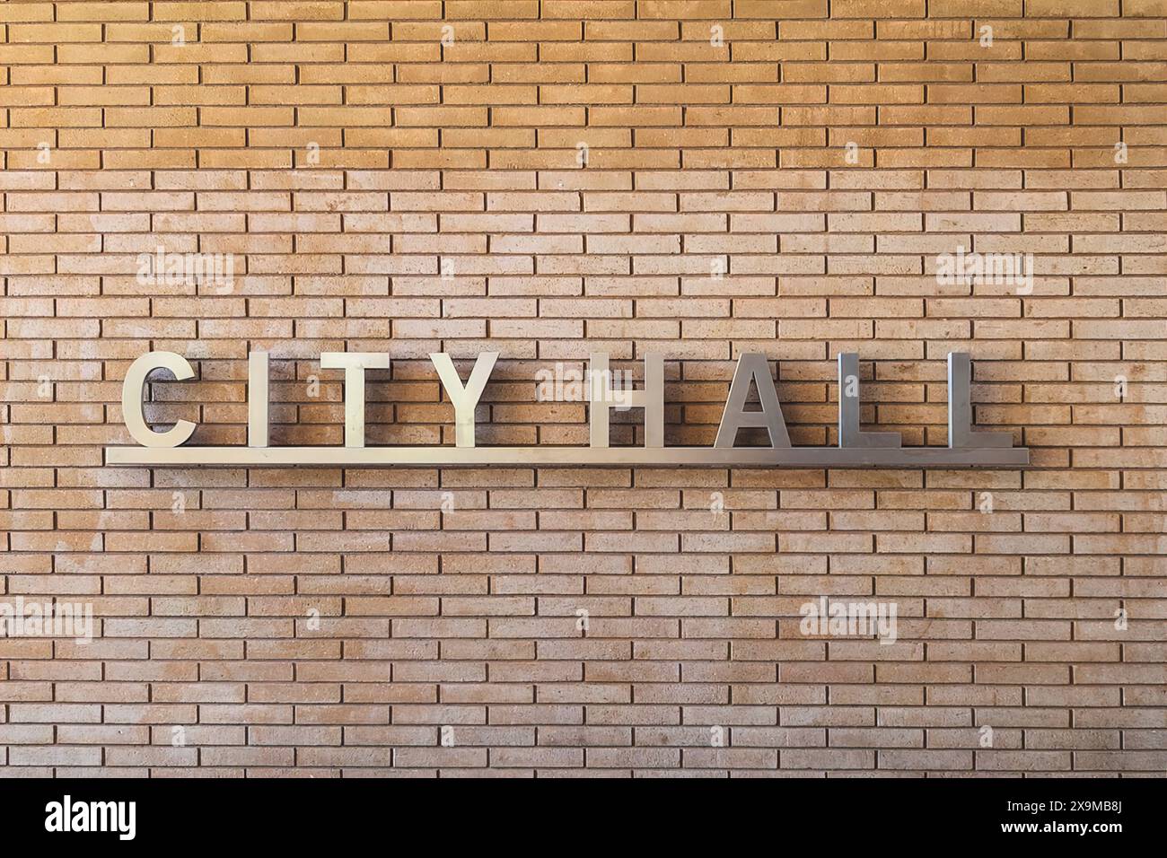 A City Hall sign on a brick wall Stock Photo - Alamy