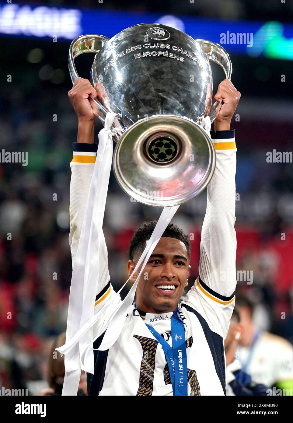 Real Madrid's Jude Bellingham celebrates with the trophy after winning ...