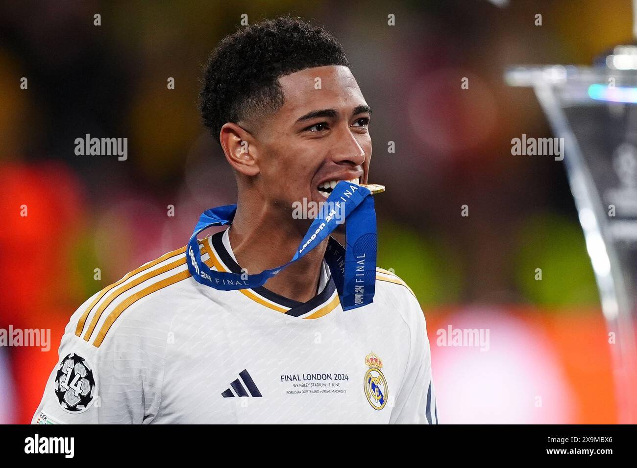 Real Madrid's Jude Bellingham bites his winners medal after winning the ...