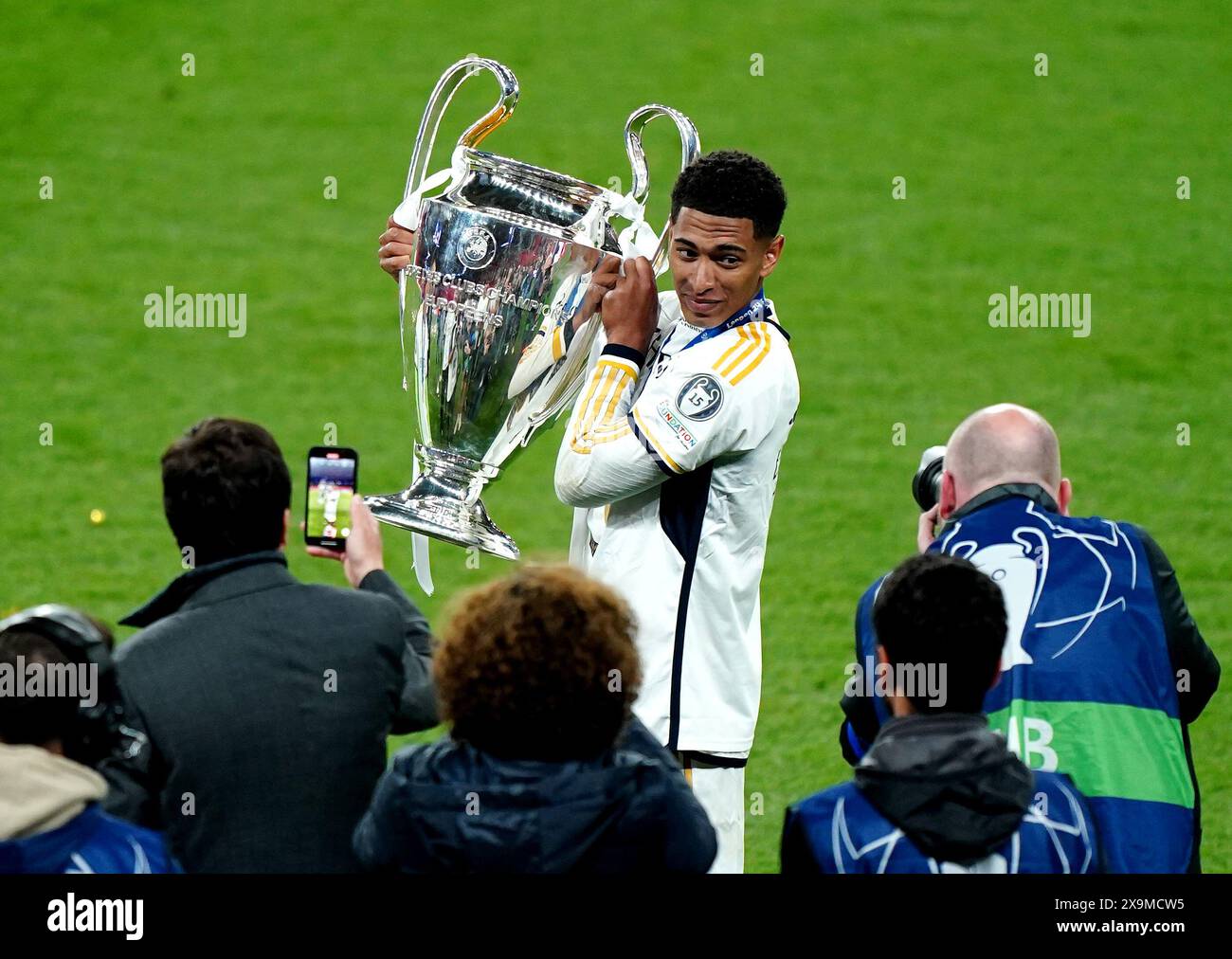 Real Madrid's Jude Bellingham celebrates with the trophy after winning ...