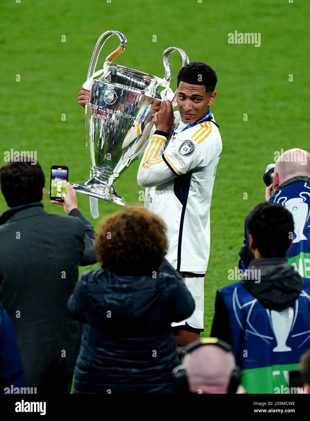 Real Madrid's Jude Bellingham celebrates with the trophy after winning ...