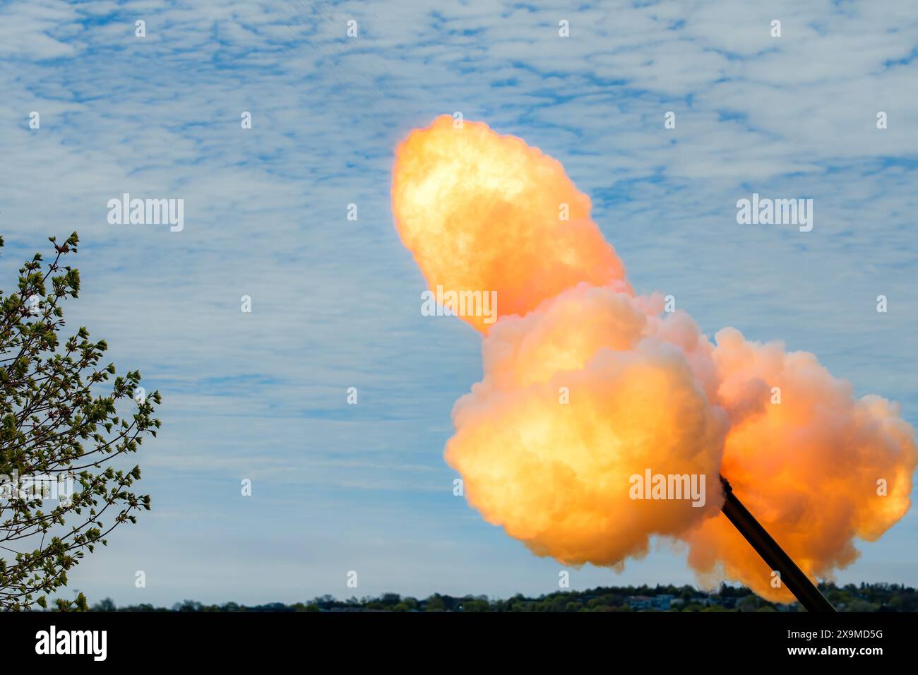 A piece of artillery fires a shell. A large plume of flame and smoke ...