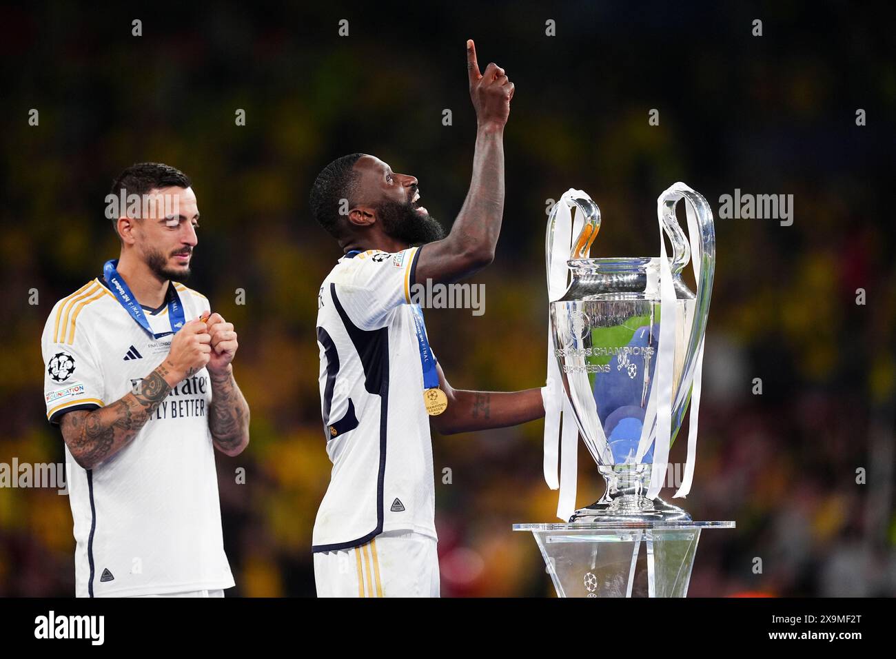 Real Madrid's Antonio Rudiger celebrates next to the trophy after ...