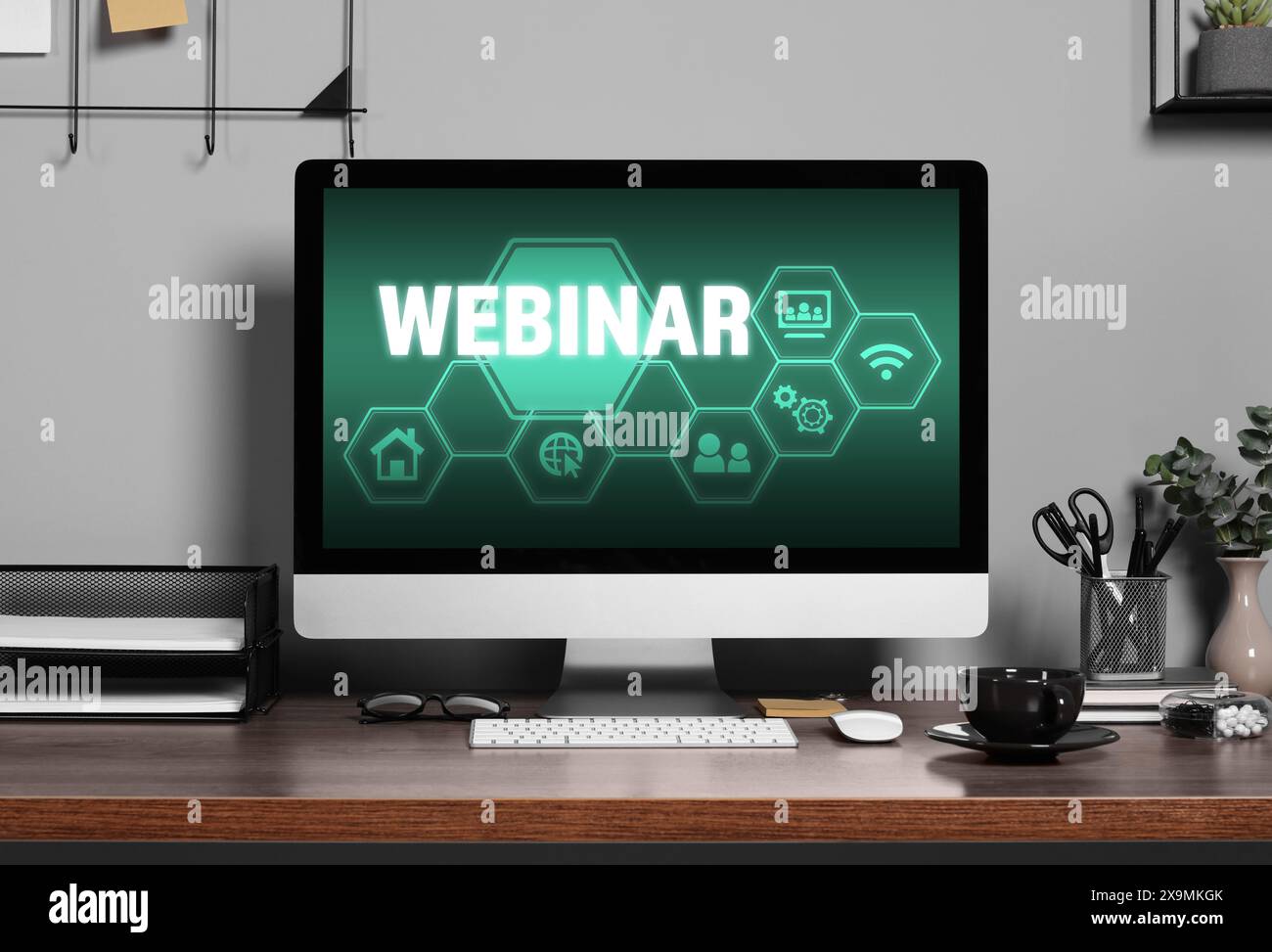 Webinar page open on computer screen at workplace Stock Photo - Alamy