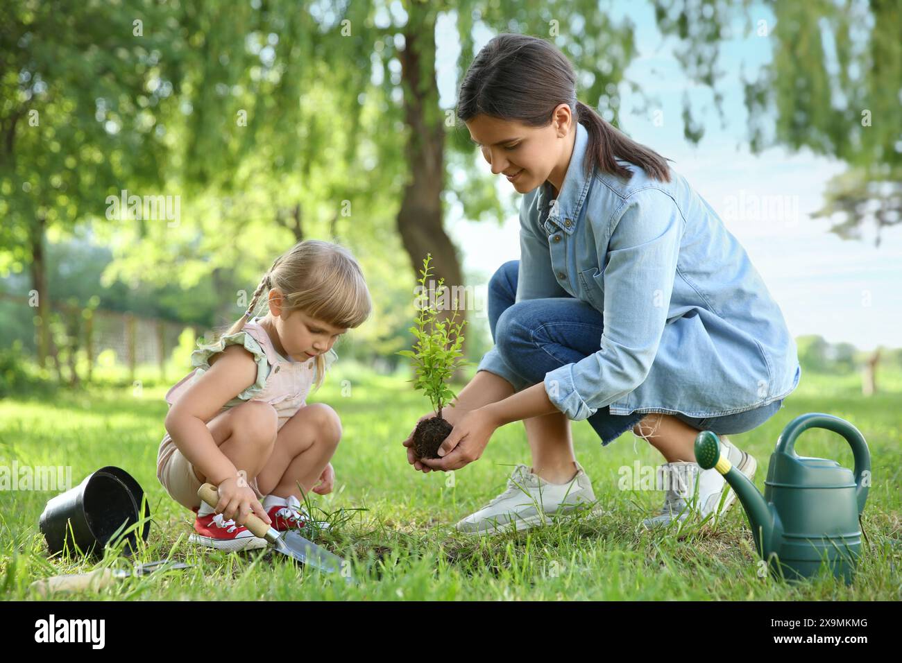 Happy caucasian daughter planting tree hi-res stock photography and ...