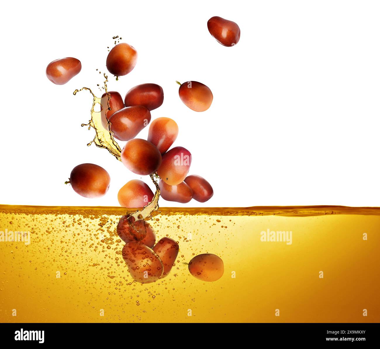 Palm fruits falling into cooking oil on white background Stock Photo ...