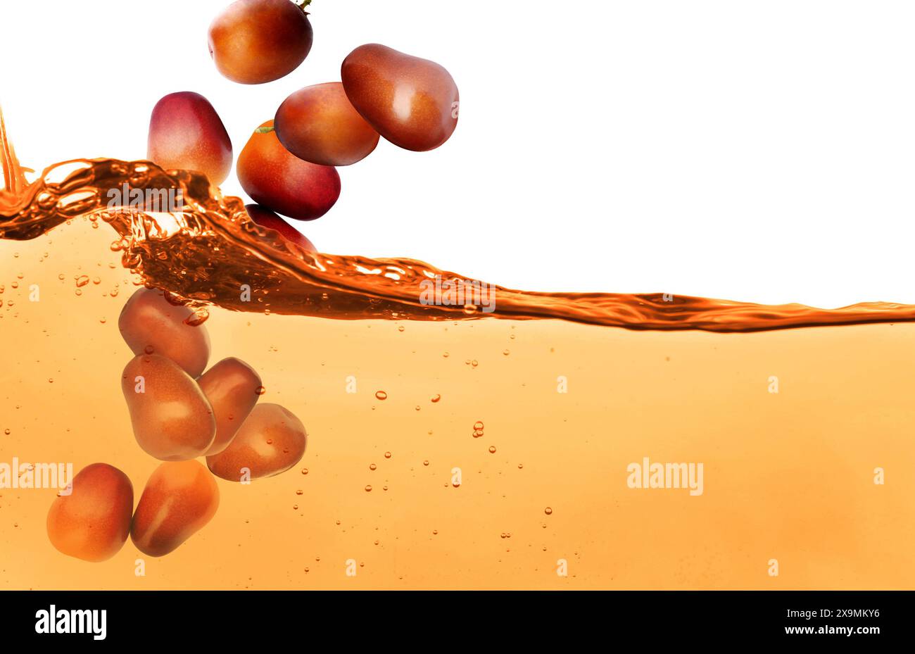 Palm fruits falling into cooking oil on white background Stock Photo ...