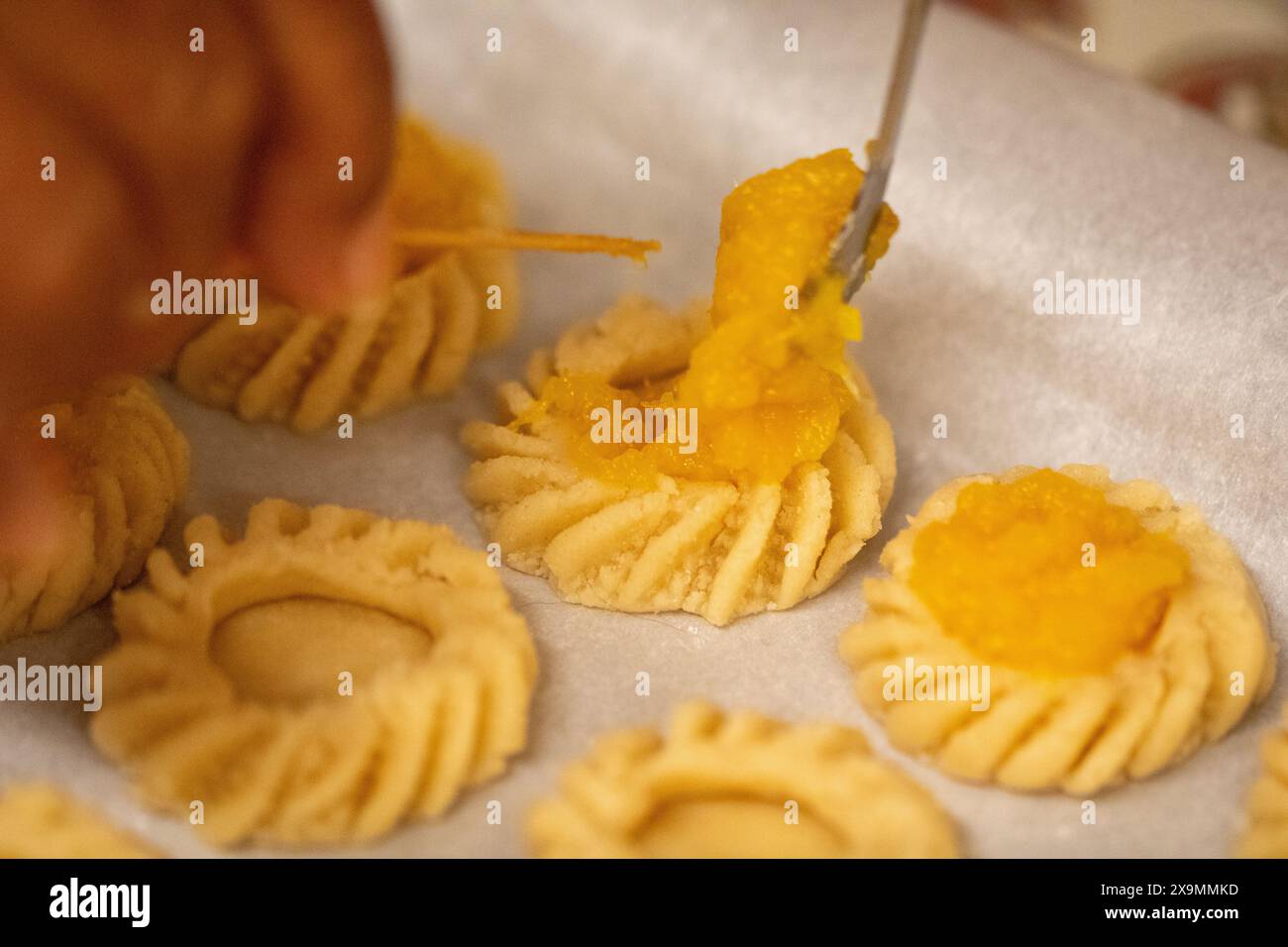 Filling sugar cookies with pineapple topping Stock Photo - Alamy