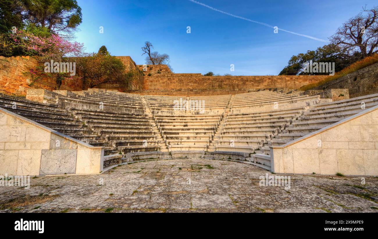 Ancient amphitheatre with stone seating steps, illuminated by soft ...