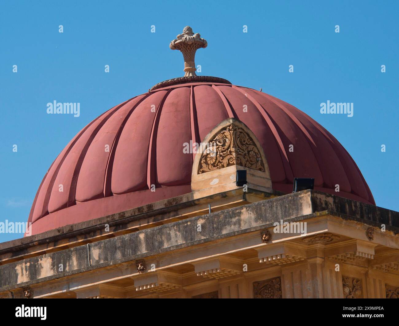 A red dome on a historic building under a clear blue sky, palermo in ...