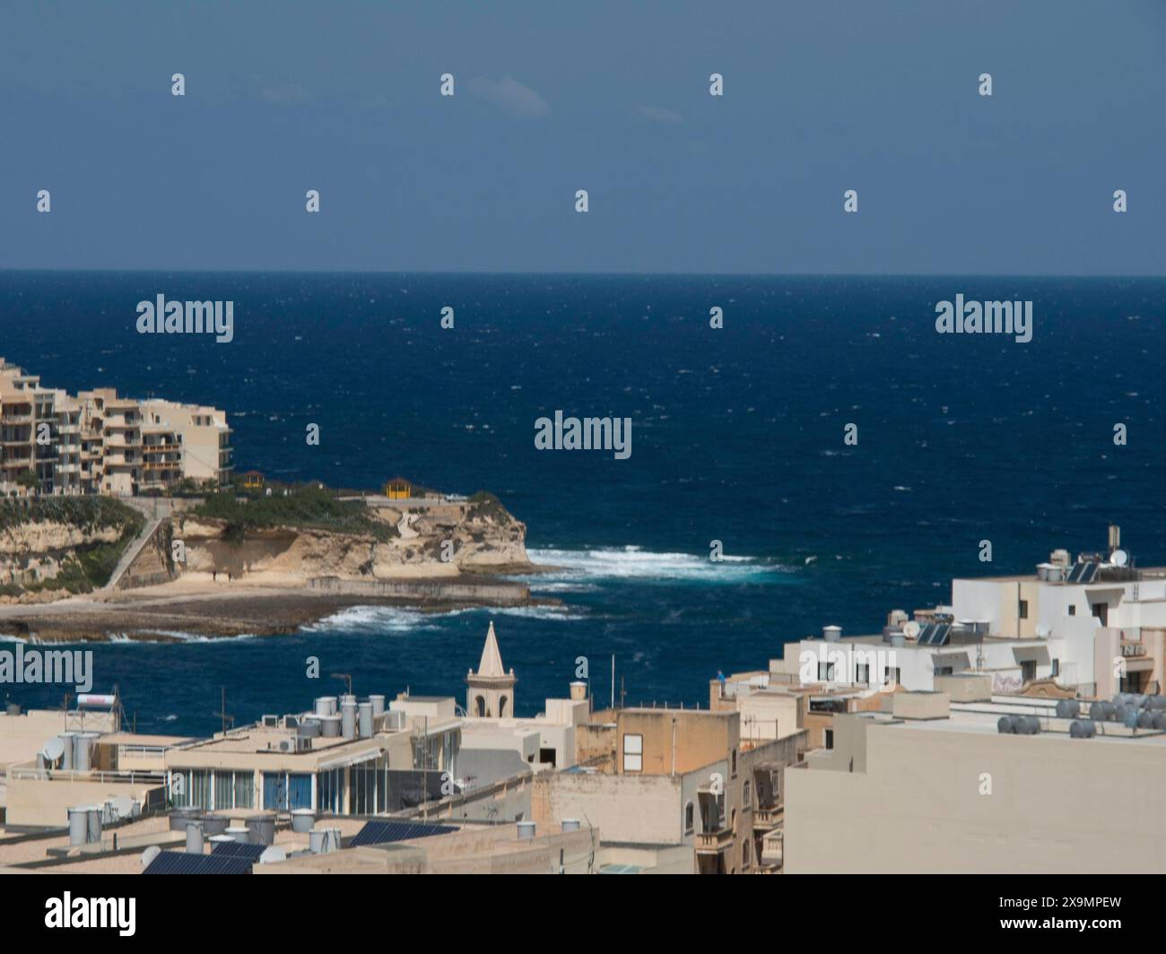 Town view of the open sea and waves crashing on the shore, the island ...