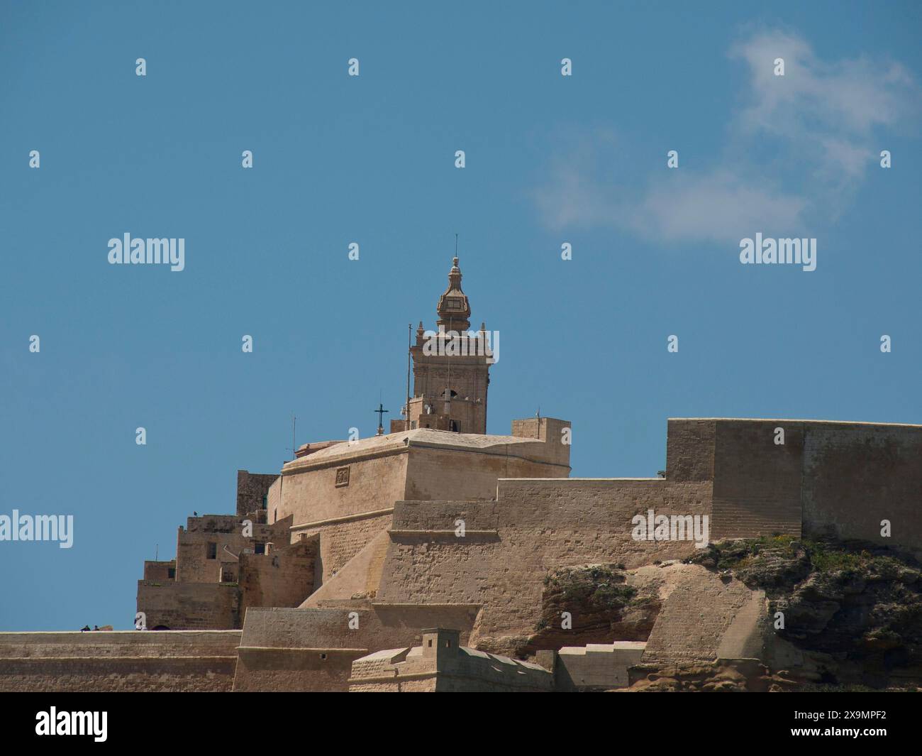 A historic fortress with a striking tower and several levels of ...