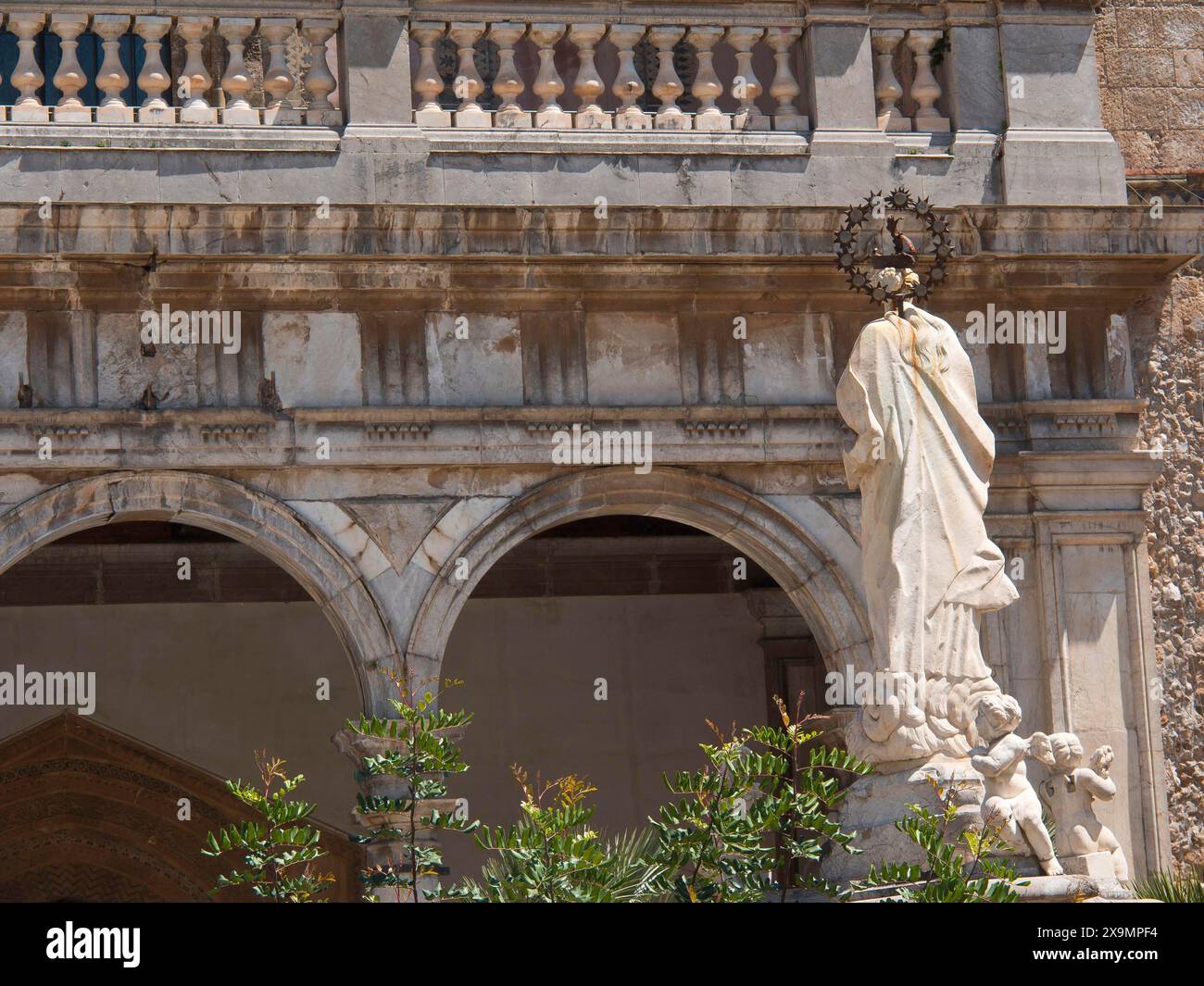 Marble sculpture of a figure and two angels in front of a church with ...
