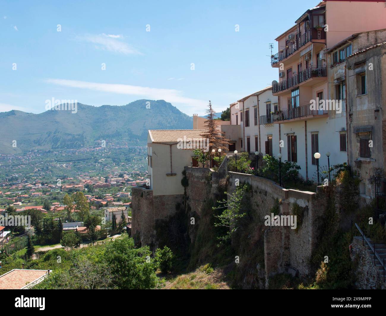 City on a hill with mediterranean houses and old city walls in front of ...