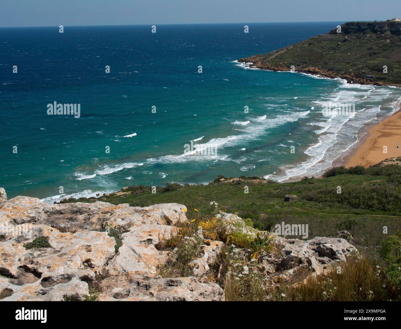 A secluded beach with calm turquoise waters and waves reaching the ...