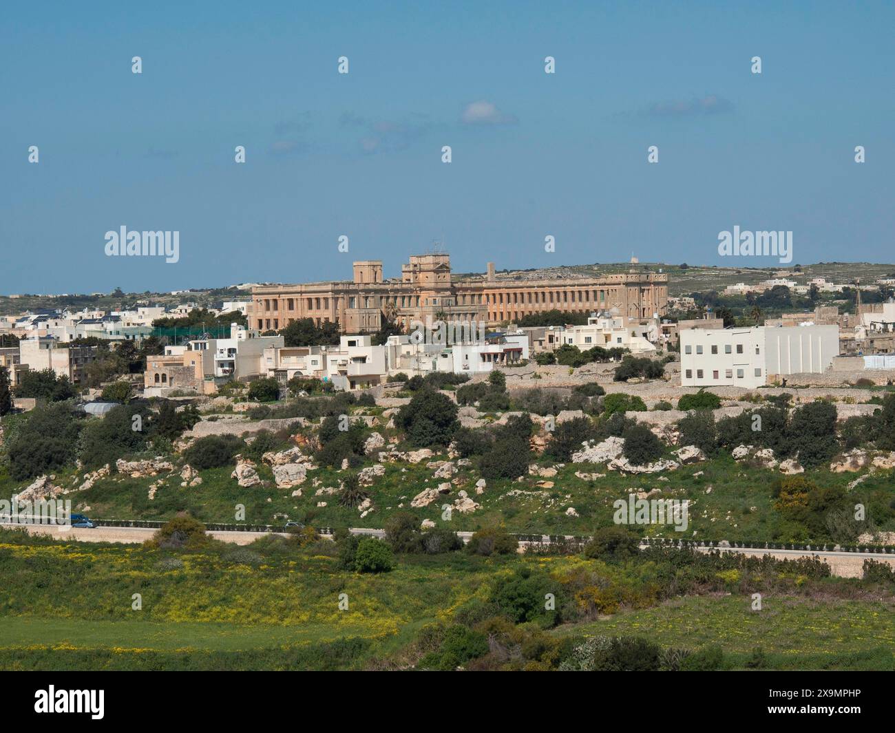 Town view with historic buildings on a hill, lots of greenery ...