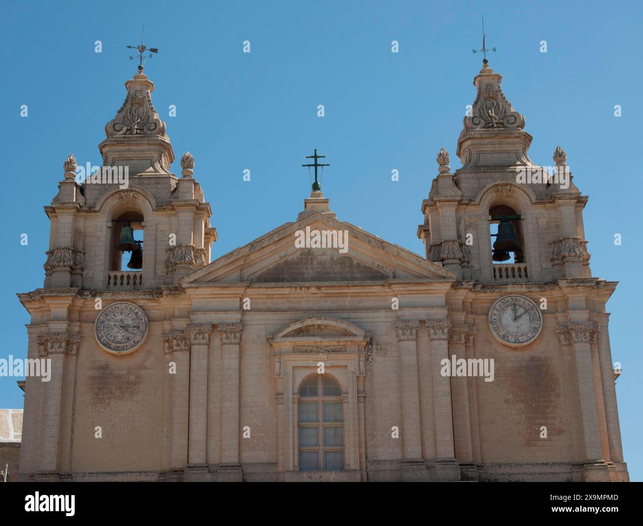 Front view of a historic church with two bell towers and clocks, the ...