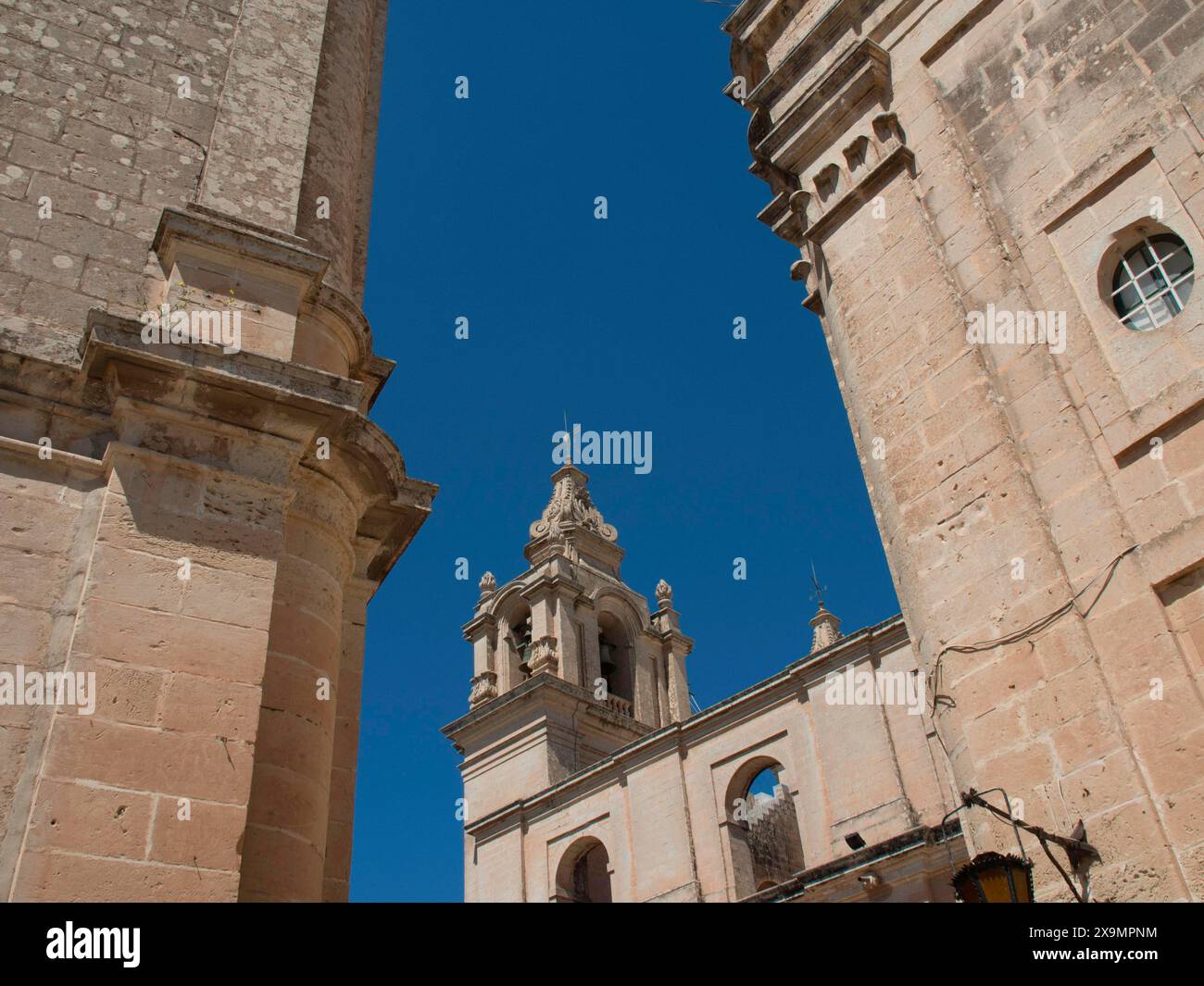 Two historic buildings standing next to each other with a church tower ...