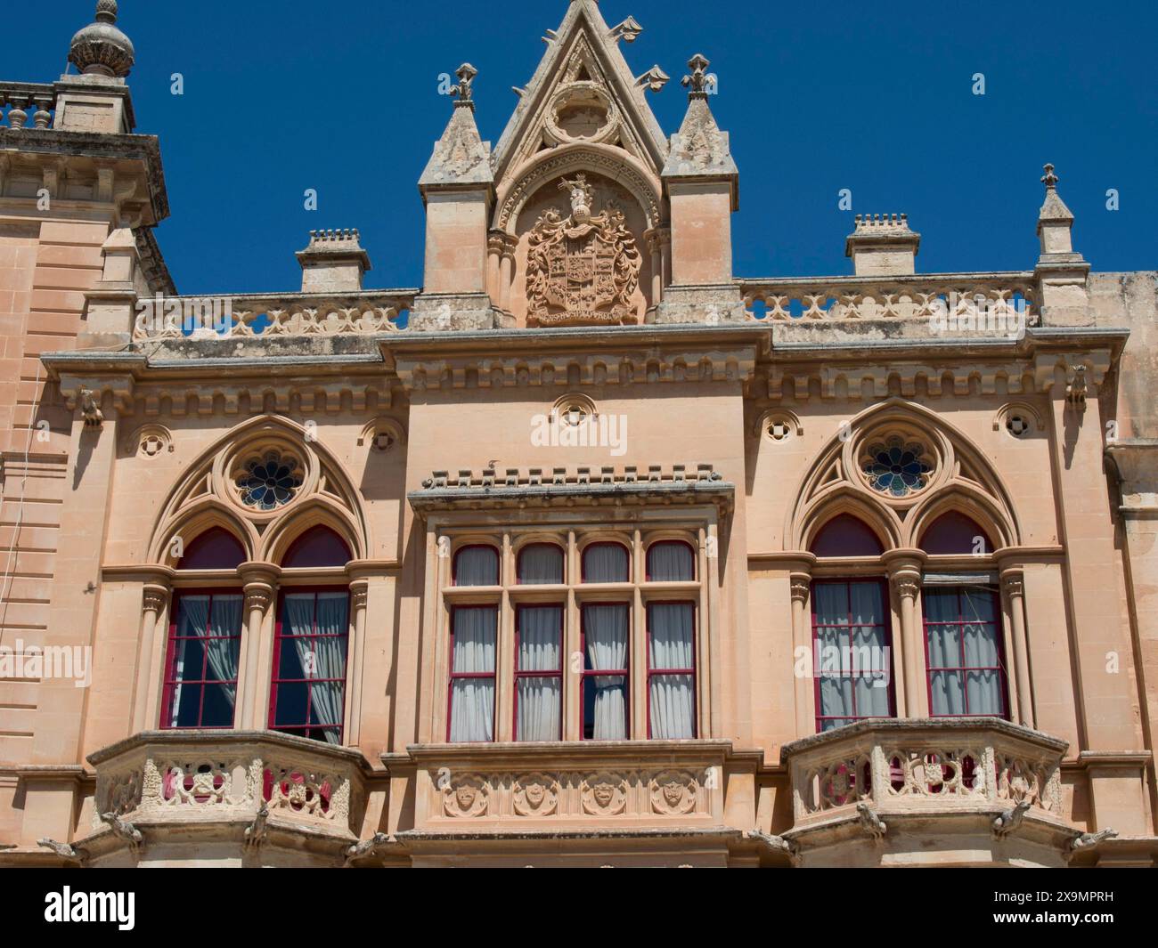 A historic building with an elaborately designed facade and balconies ...