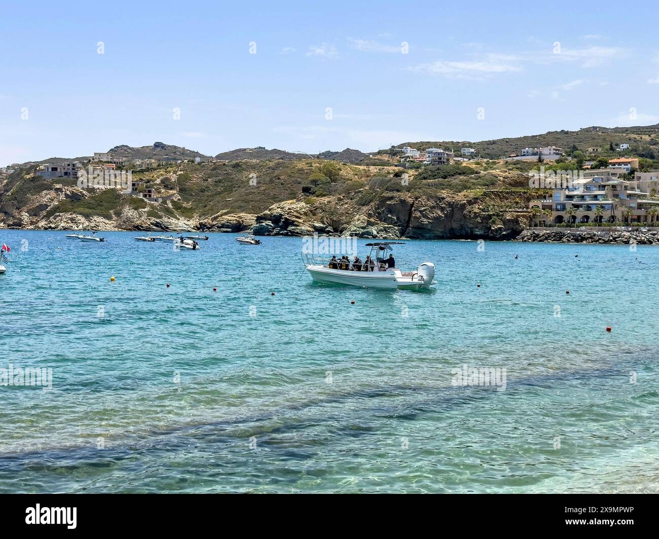 Scuba divers take a dive boat out of the bay of the holiday resort of ...