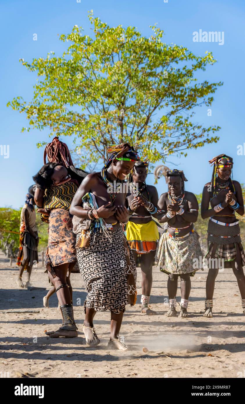 Hakaona woman with traditional kapapo hairstyle and Himba woman ...