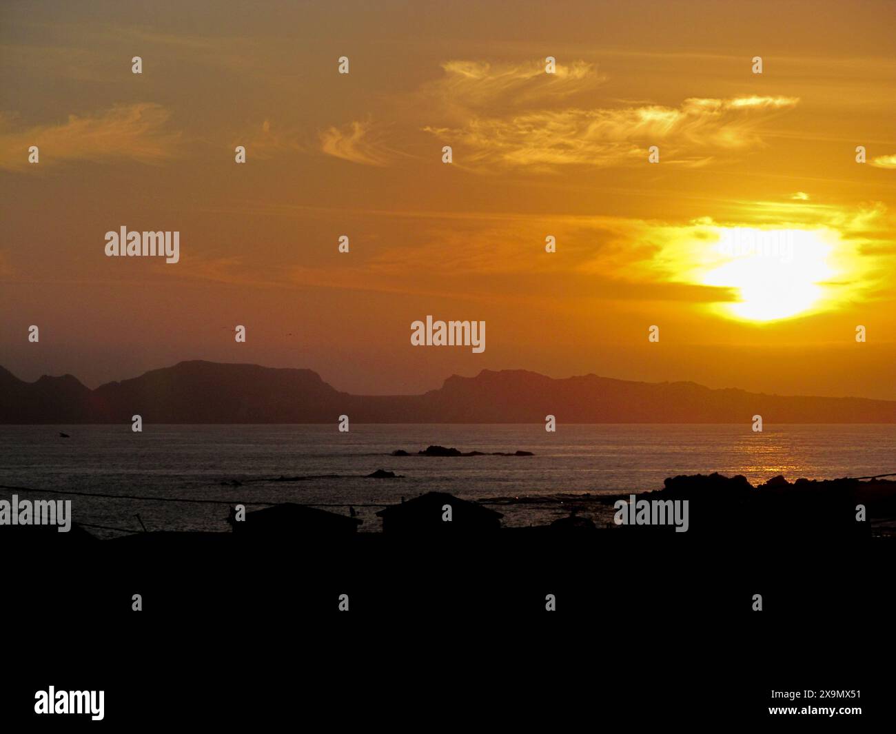 Golden sunset at Punta de Choros beach, north Chile. Choros island at ...