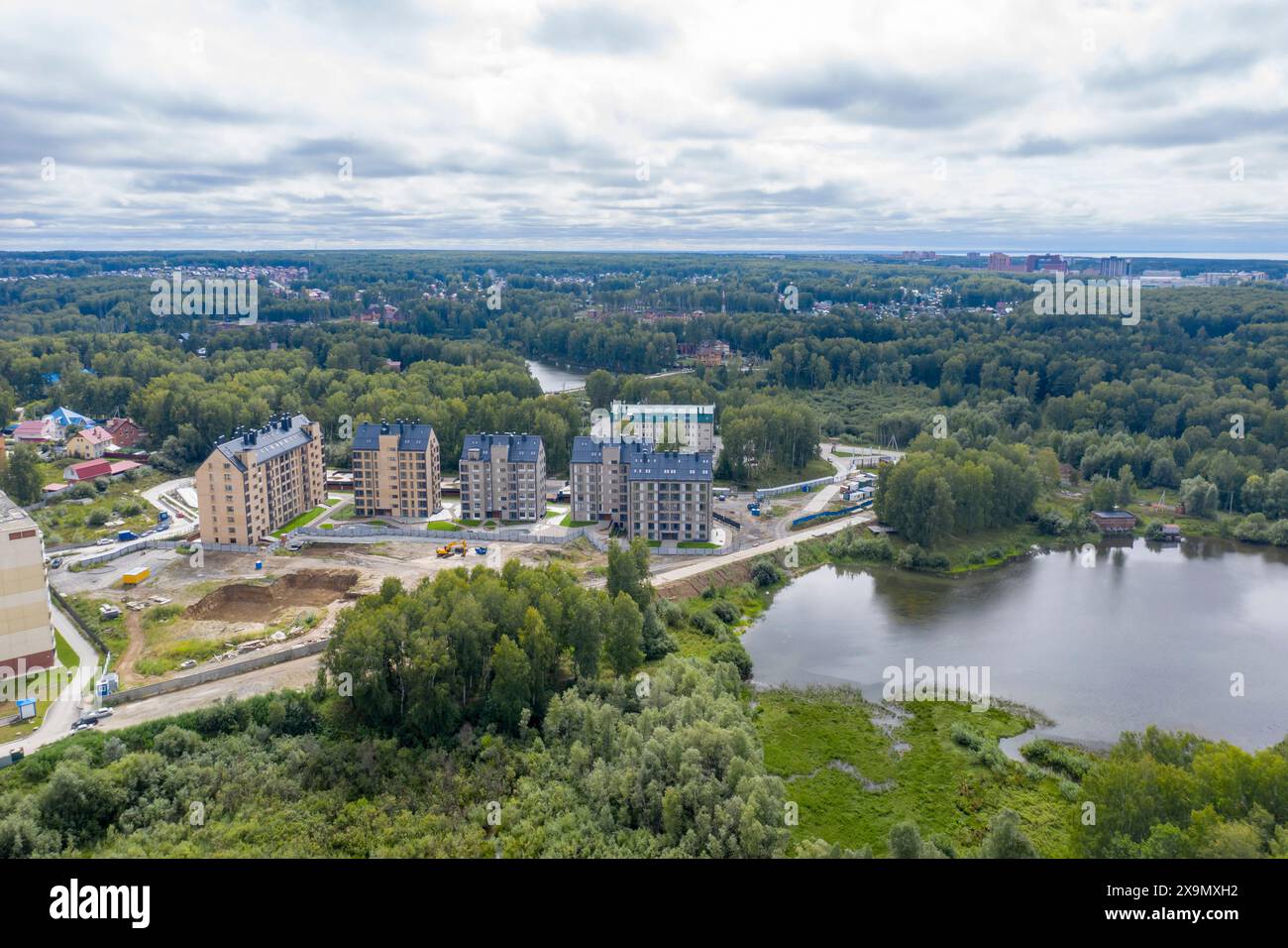 Aerial view of the construction of a small town surrounded by forests ...