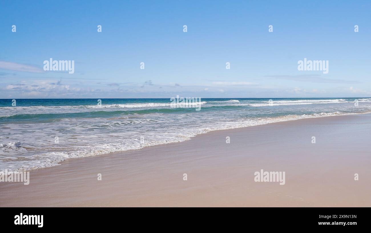 Panoramic beach scene with wet smooth sand, sea, breaking waves ...