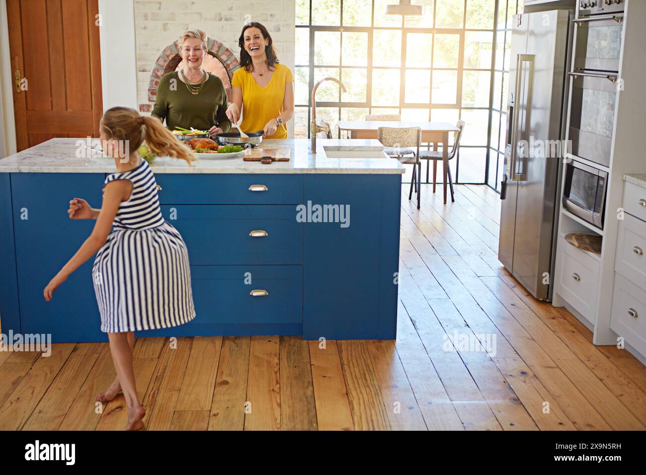 Happy, dancing and child spin in kitchen with music, fun and family ...