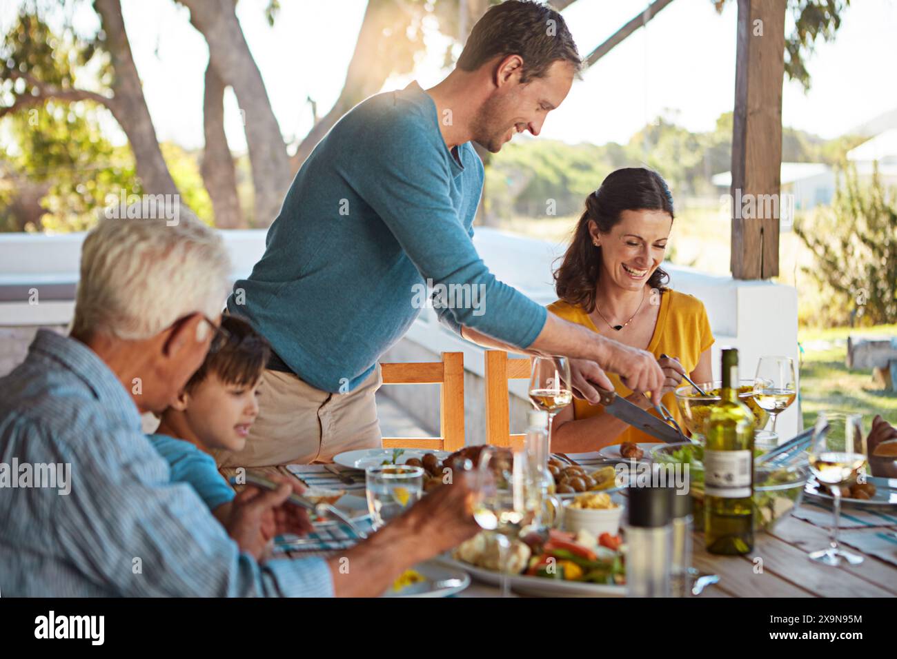 Happy family, eating and lunch with laughing outdoor on patio with ...