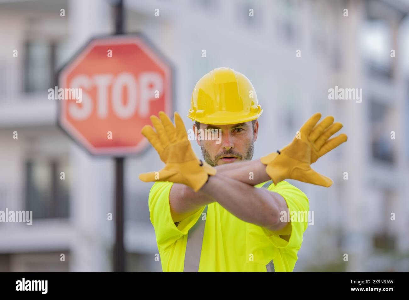 Builder with stop road sign. Builder with stop gesture, no hand ...