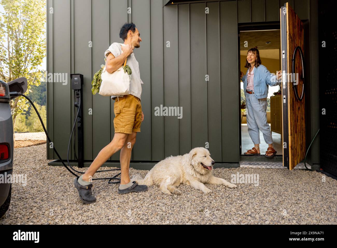 Happy family walking dog near house hi-res stock photography and images ...