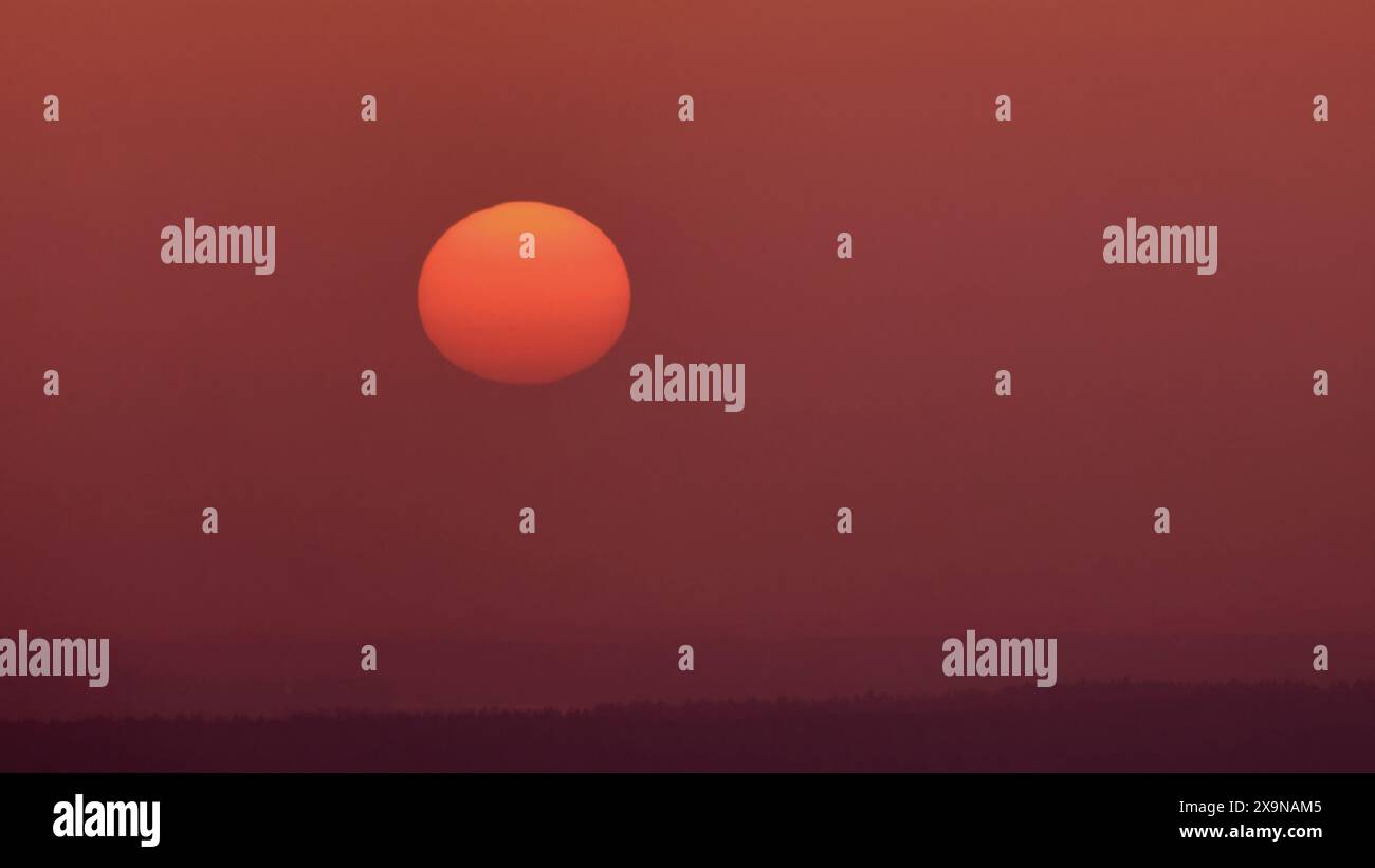 The sun sets in the mysterious haze of the evening red sky Stock Photo ...