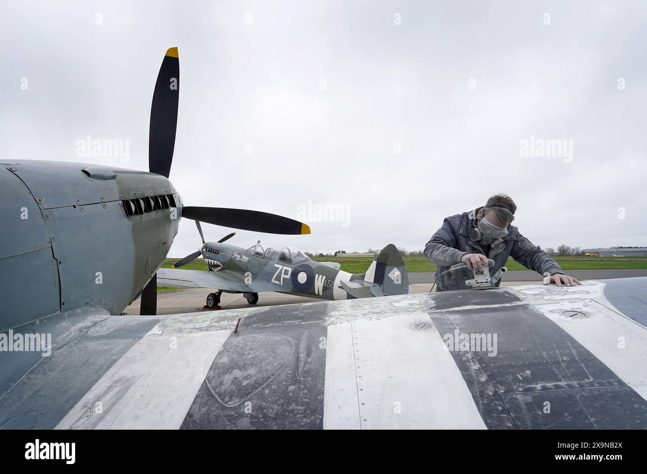 A engineer works to prepare a Spitfire outside the Heritage Hangar at ...