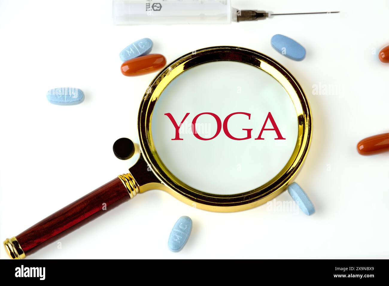 The word YOGA written through a magnifying glass on a white background ...