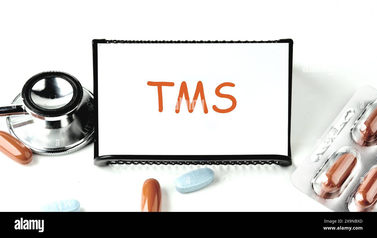 The acronym TMS transportation management system. Written on a white business card on a stand on ...