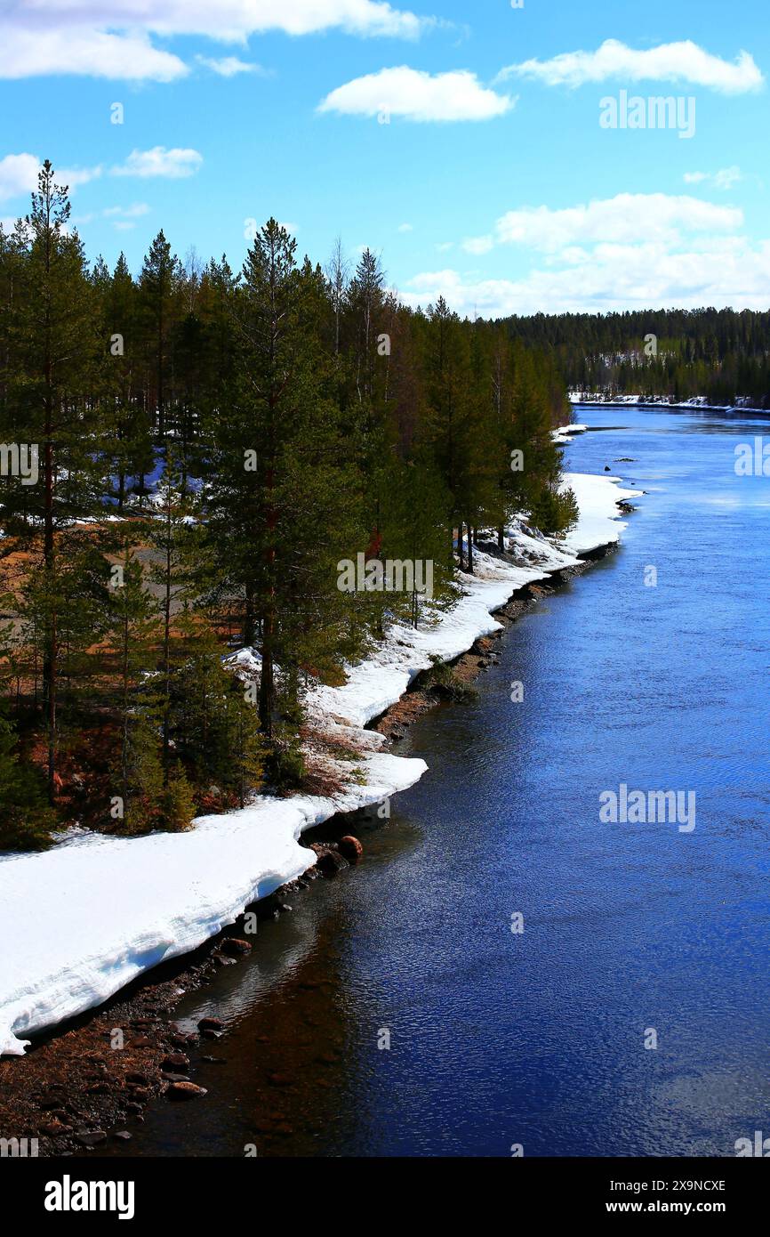 Frozen riverside of Skellefte river with sunlight in northern Sweden ...