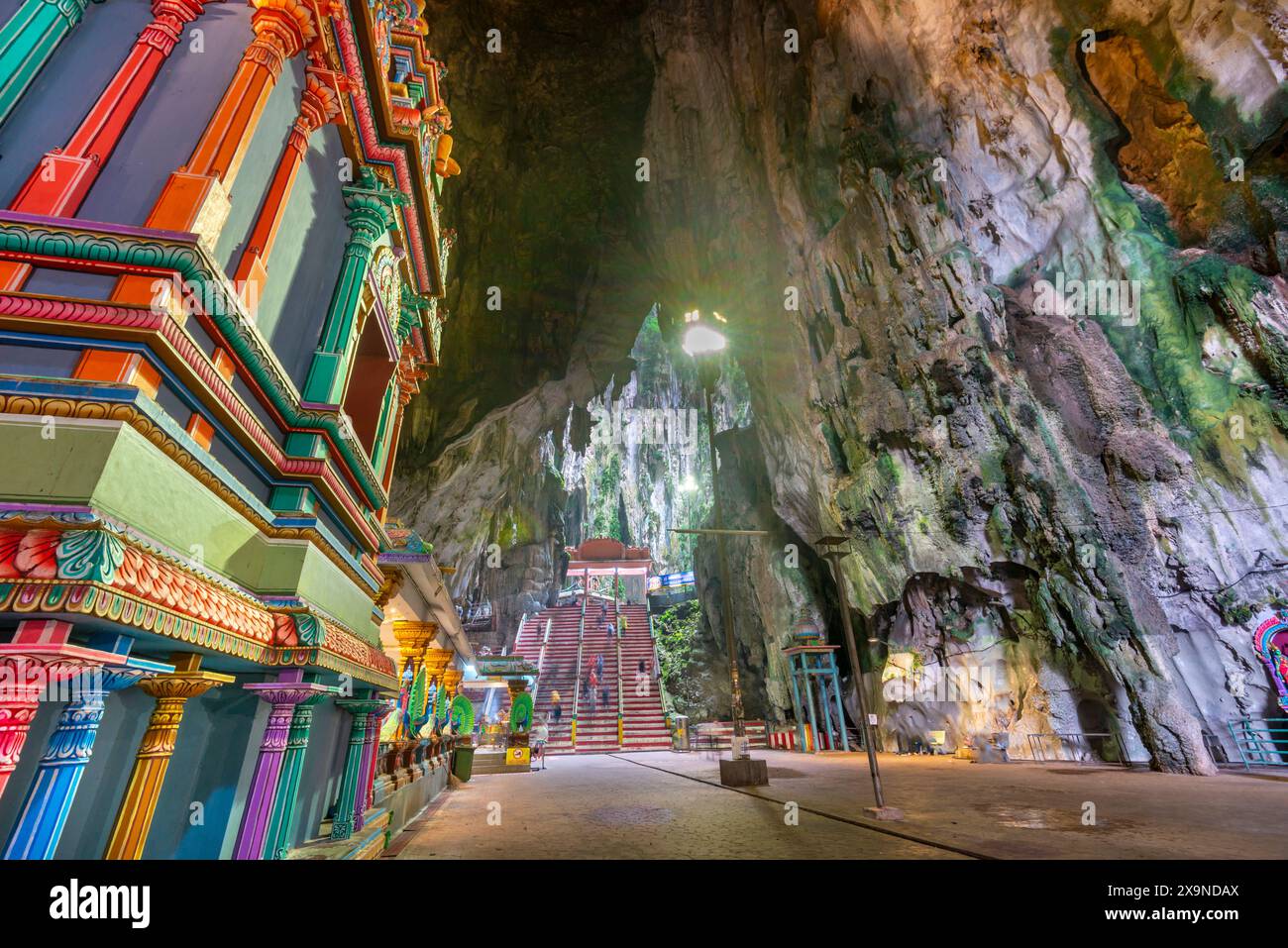 Visitors go through the tall cave entrance,down a flight of stairs,into ...