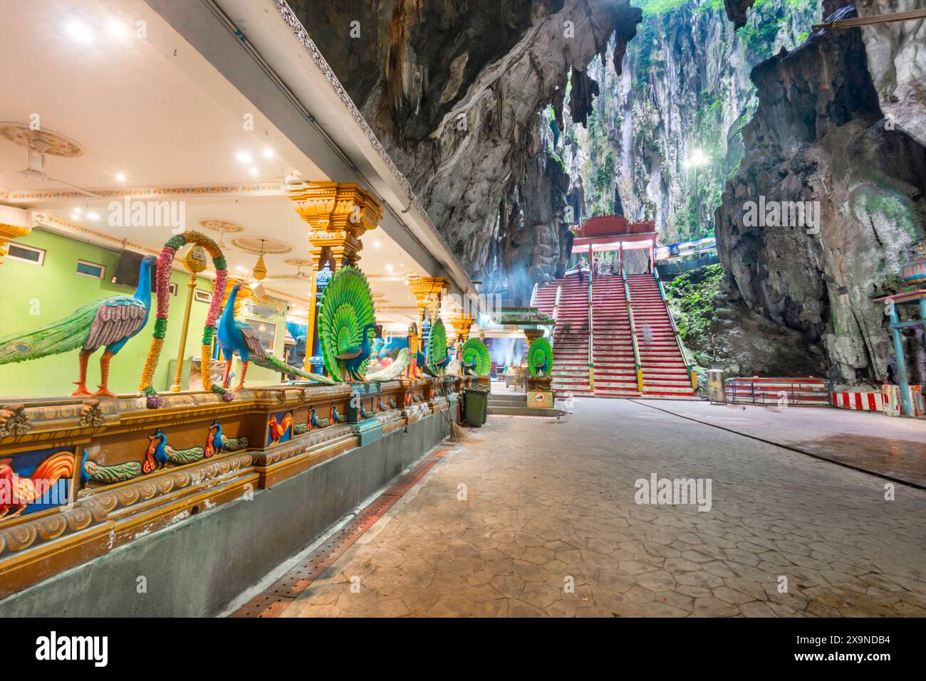 Visitors go through the tall cave entrance,down a flight of stairs,into ...