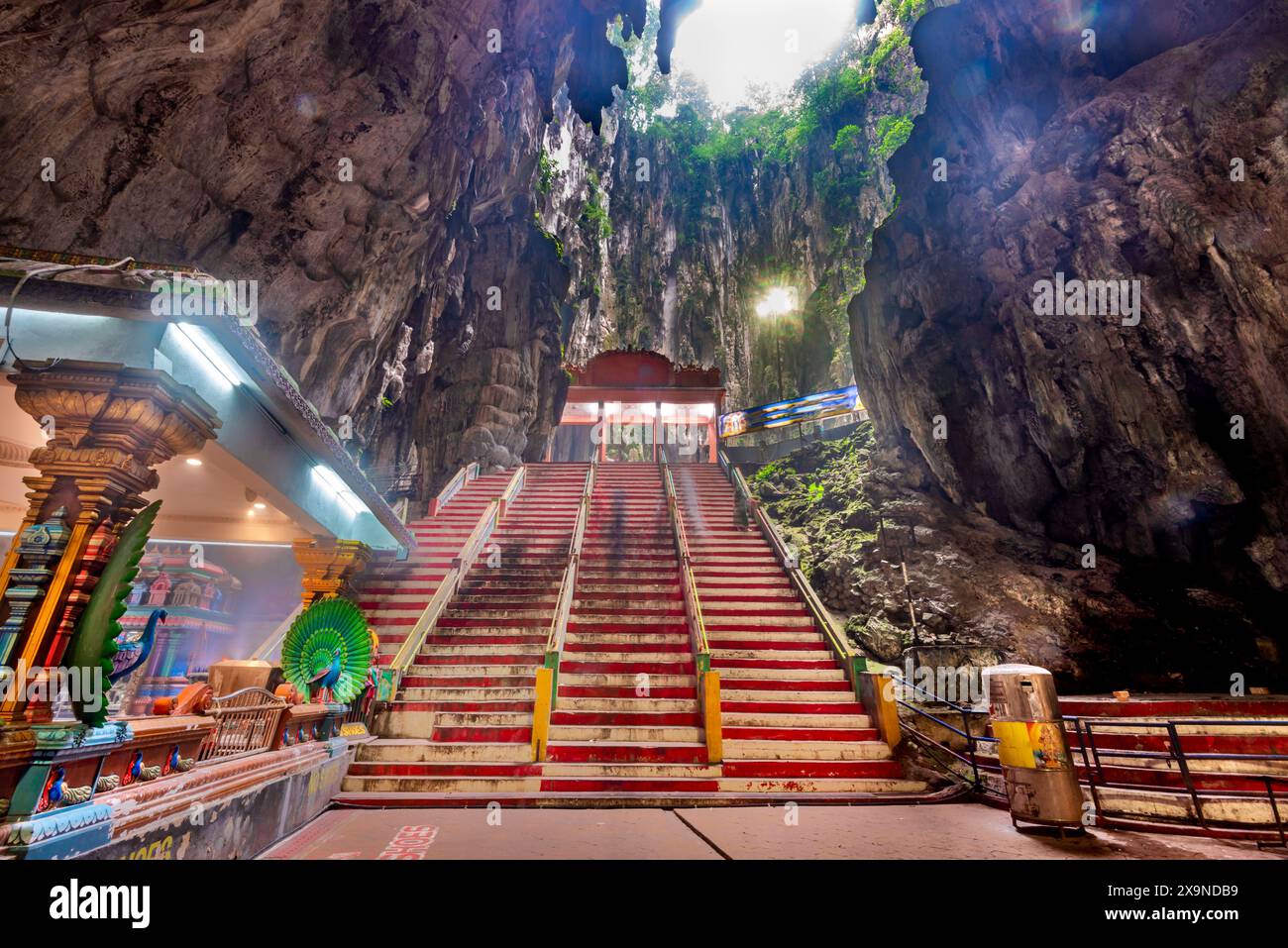 Visitors go through the tall cave entrance,down a flight of stairs,into ...