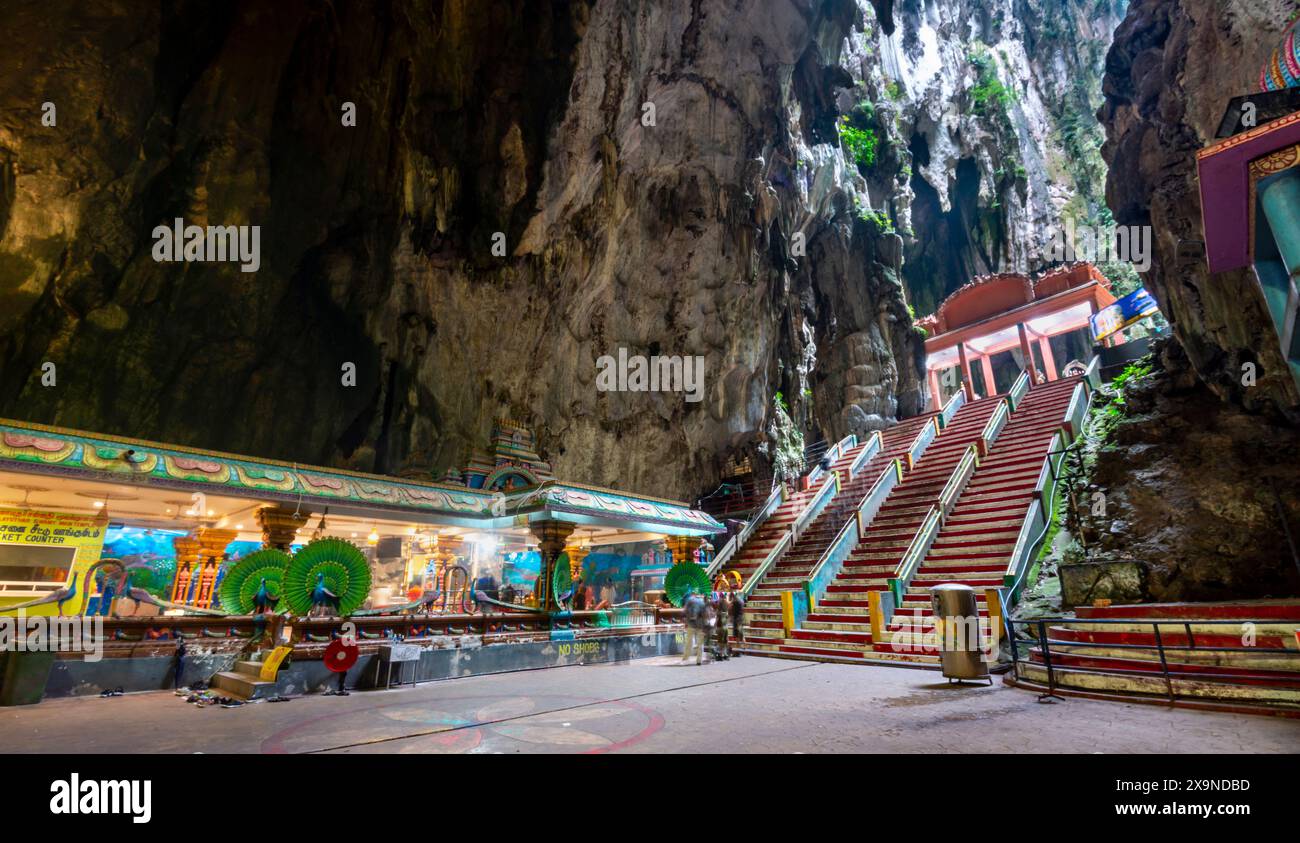 Visitors go through the tall cave entrance,down a flight of stairs,into ...