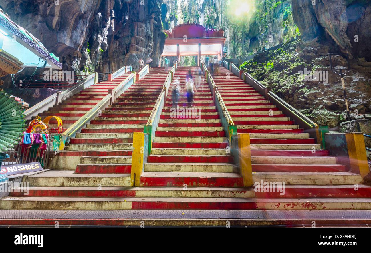 Visitors go through the tall cave entrance,down a flight of stairs,into ...