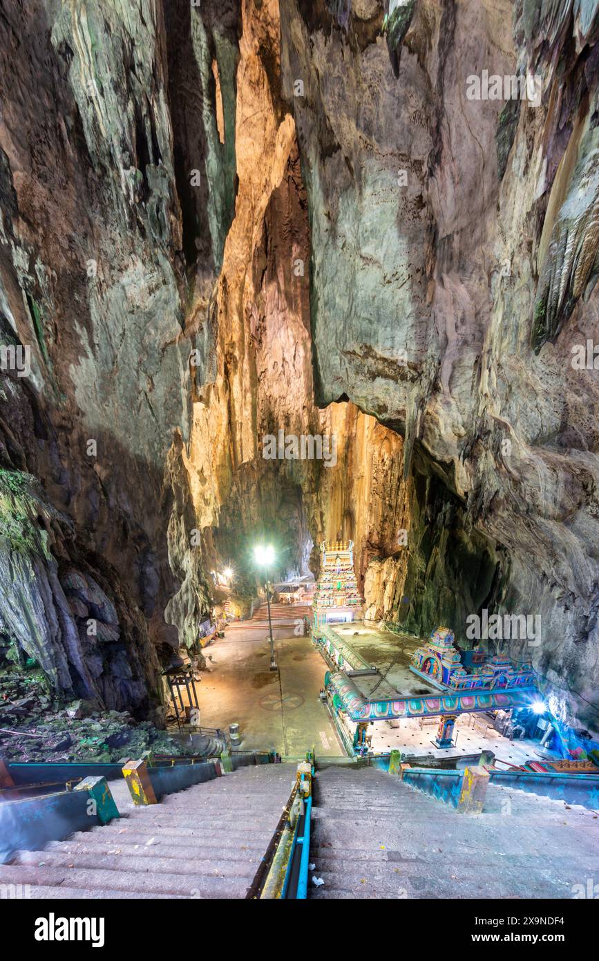 Visitors go through the tall cave entrance,down a flight of stairs,into ...