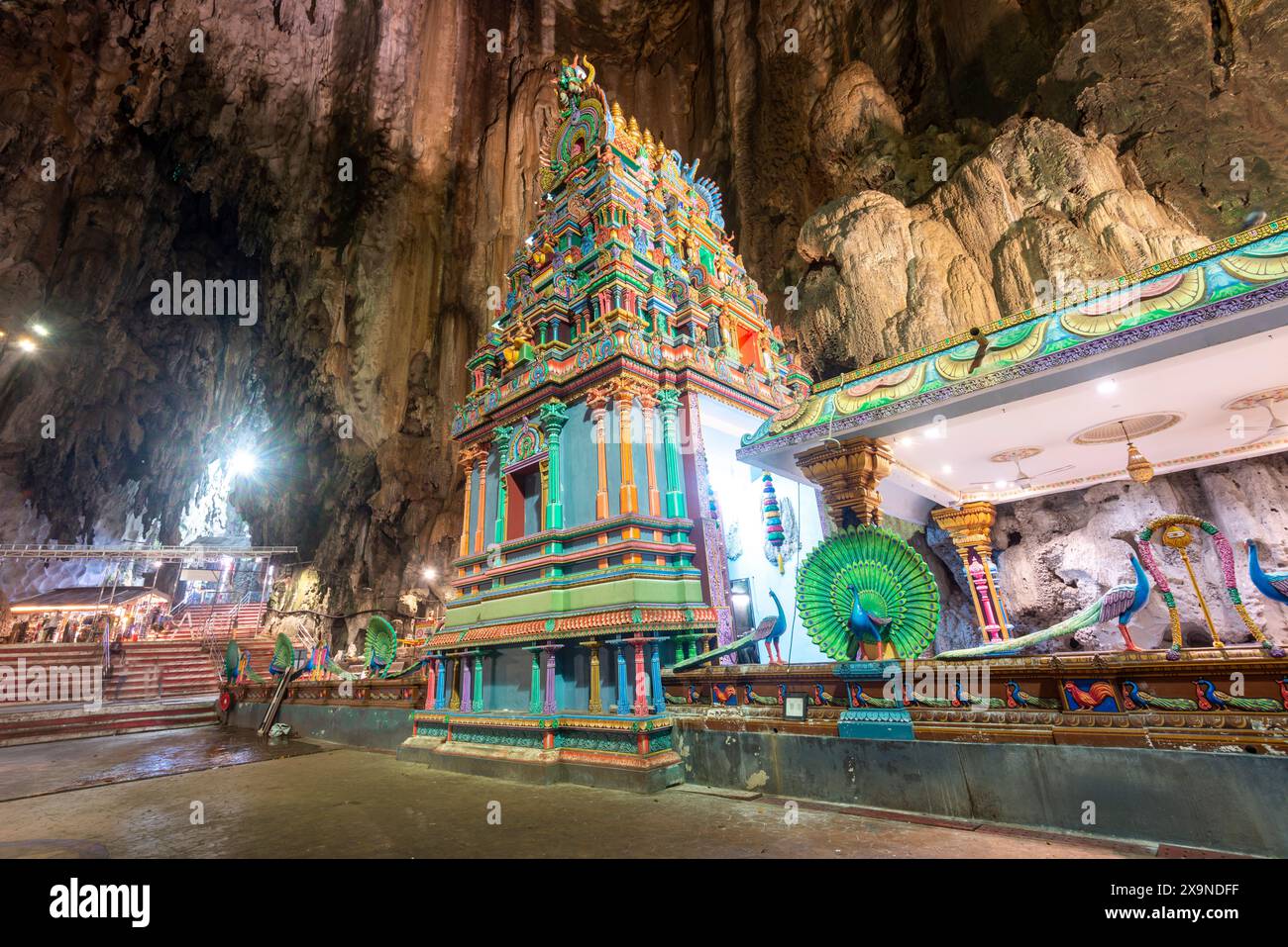 Visitors go through the tall cave entrance,down a flight of stairs,into ...