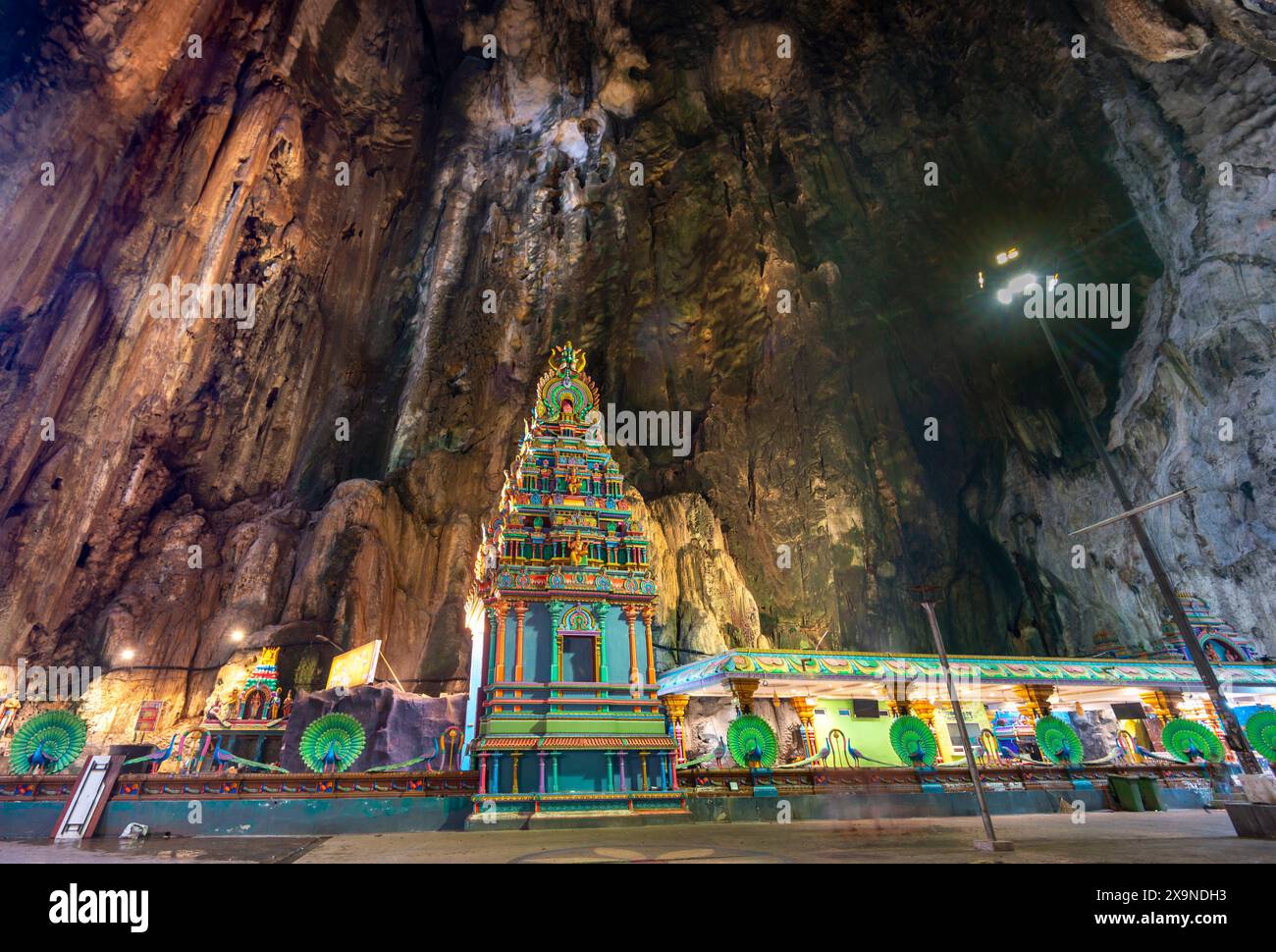 Visitors go through the tall cave entrance,down a flight of stairs,into ...