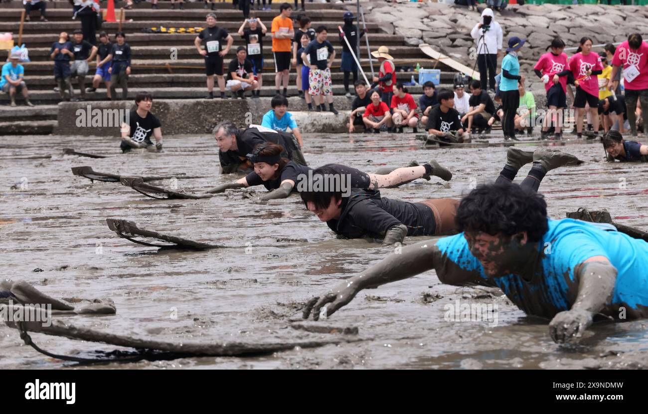 Participants compete for the goal spot in the surfboard race during the ...