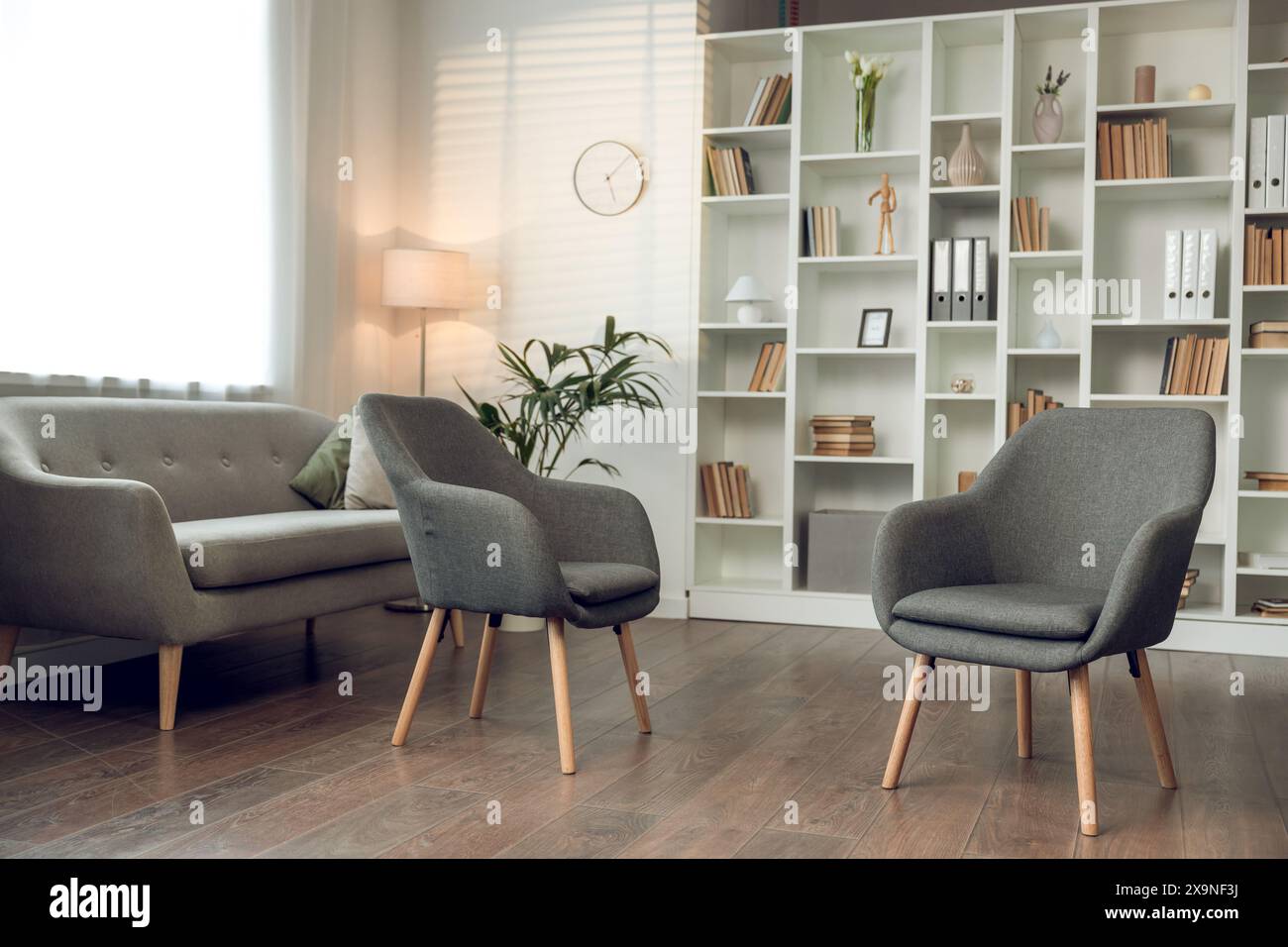 Psychologists office with cozy chairs sofa and shelves with books Stock ...