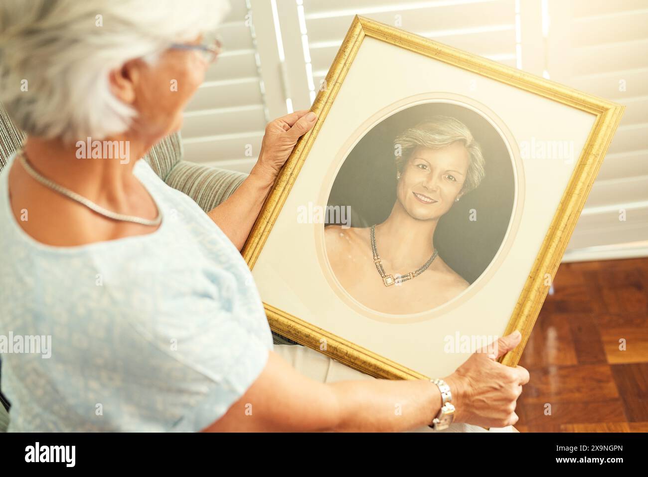 Senior woman, picture and memory in home, photography and thinking on past life in retirement ...
