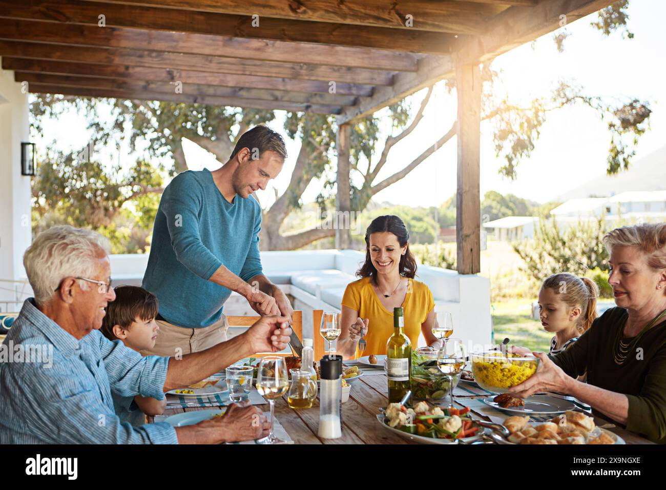 Happy family, eating and lunch with food outdoor on patio with ...